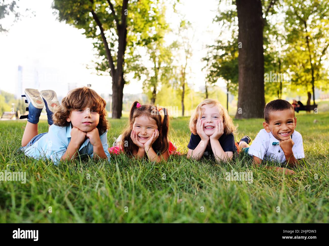 preschool children playing in the Park on the grass Stock Photo - Alamy