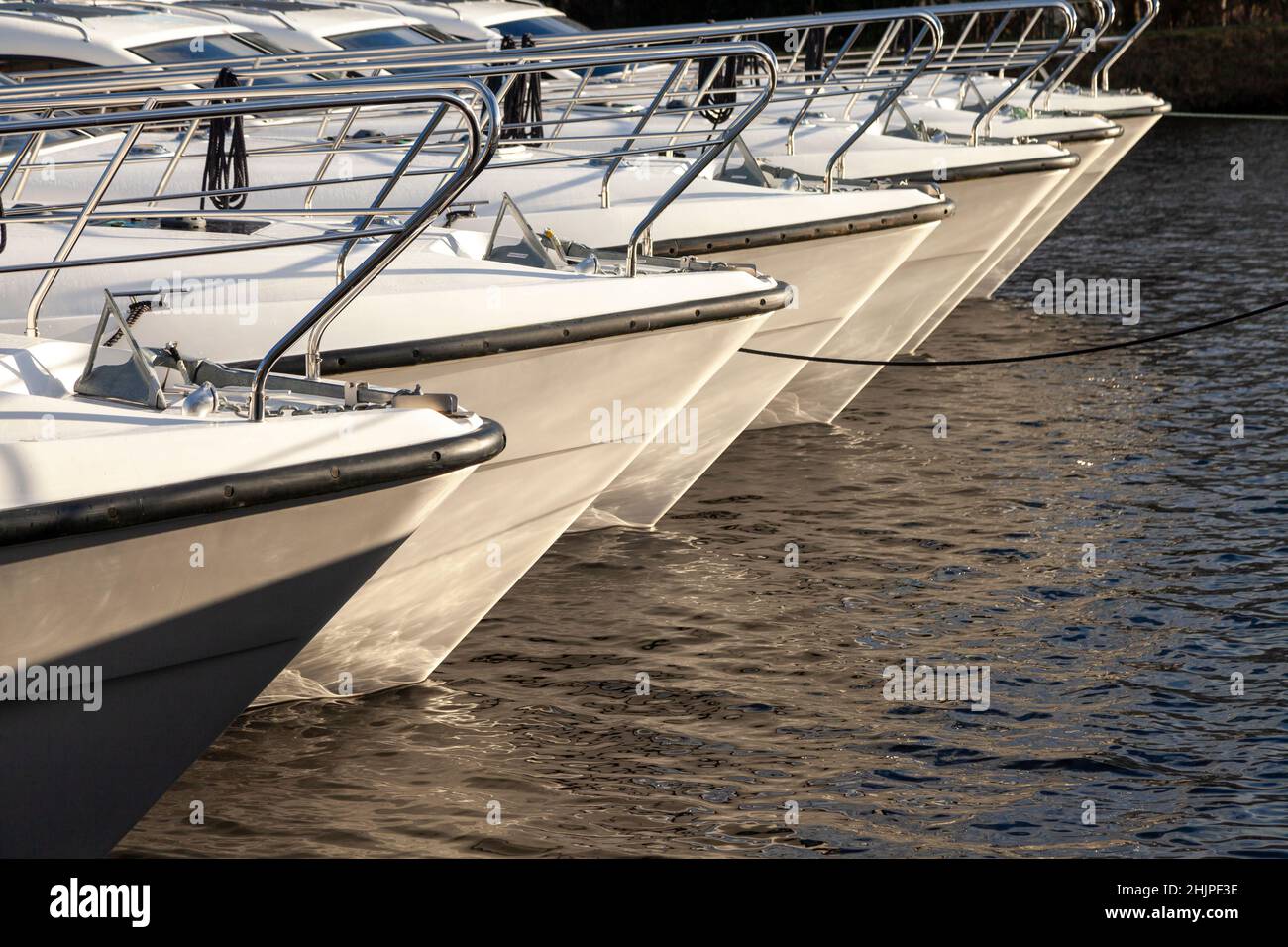 The hulls of motor boats in row in Caley marina Stock Photo - Alamy