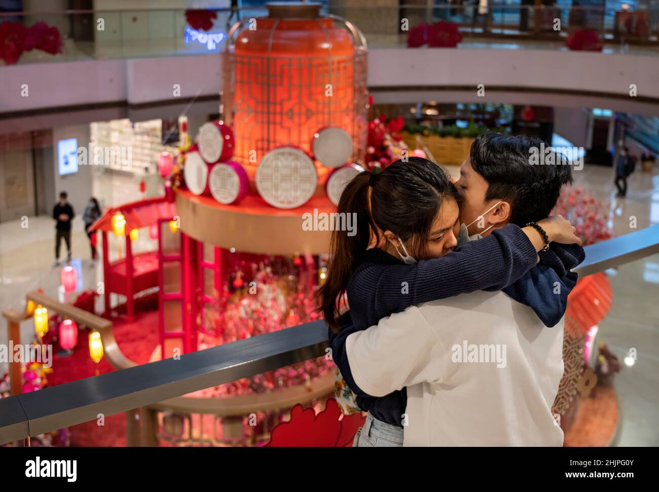 A couple hugs near a Chinese New Year theme installation for the ...