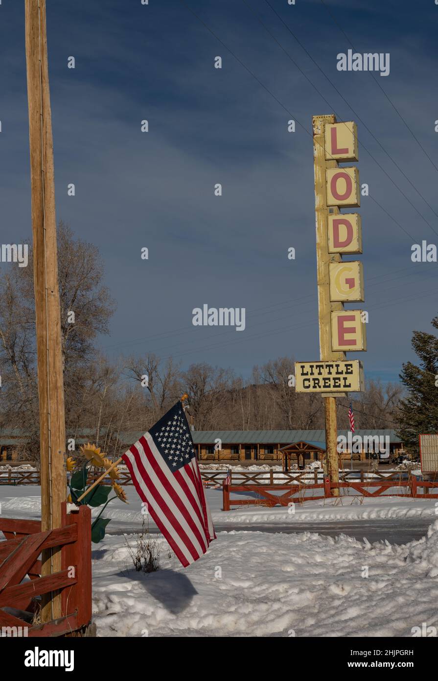 U.S. flag, sign for the Little Creel Lodge and motel rooms, the ground ...