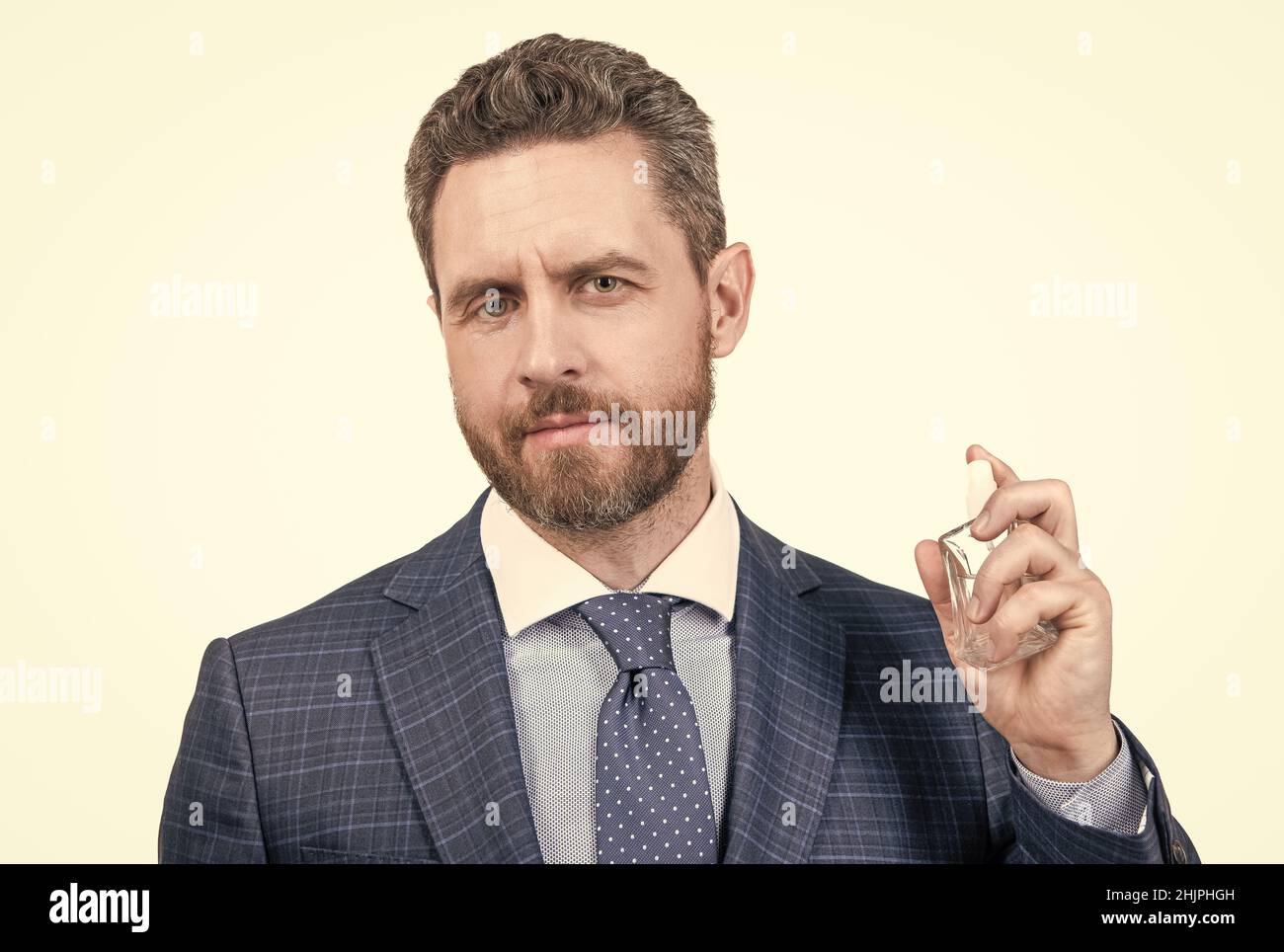 handsome businessman man in businesslike suit spraying male cosmetic ...