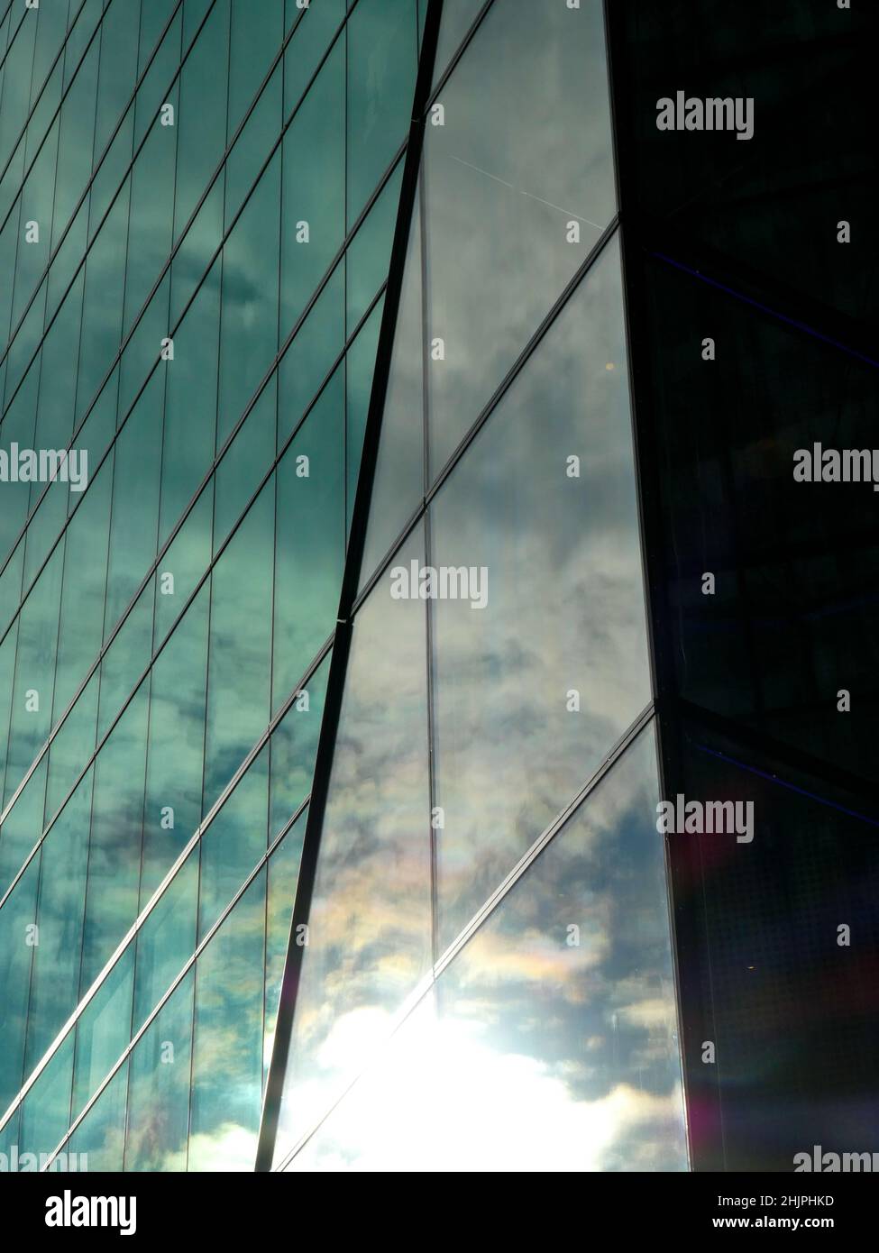 a modern glass office block reflecting a dramatic sky Stock Photo - Alamy