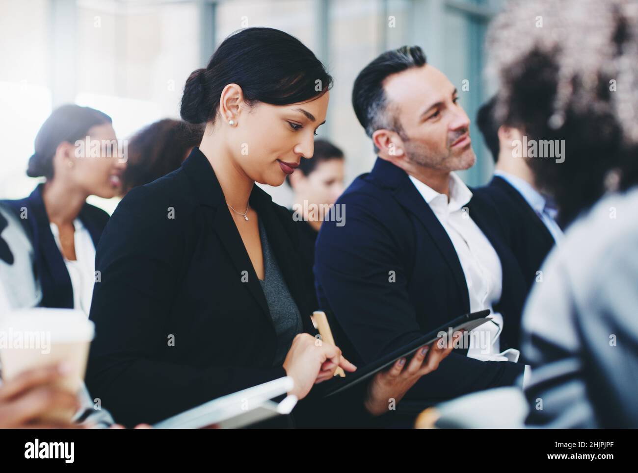 Taking as much info as she can from this presentation Stock Photo - Alamy