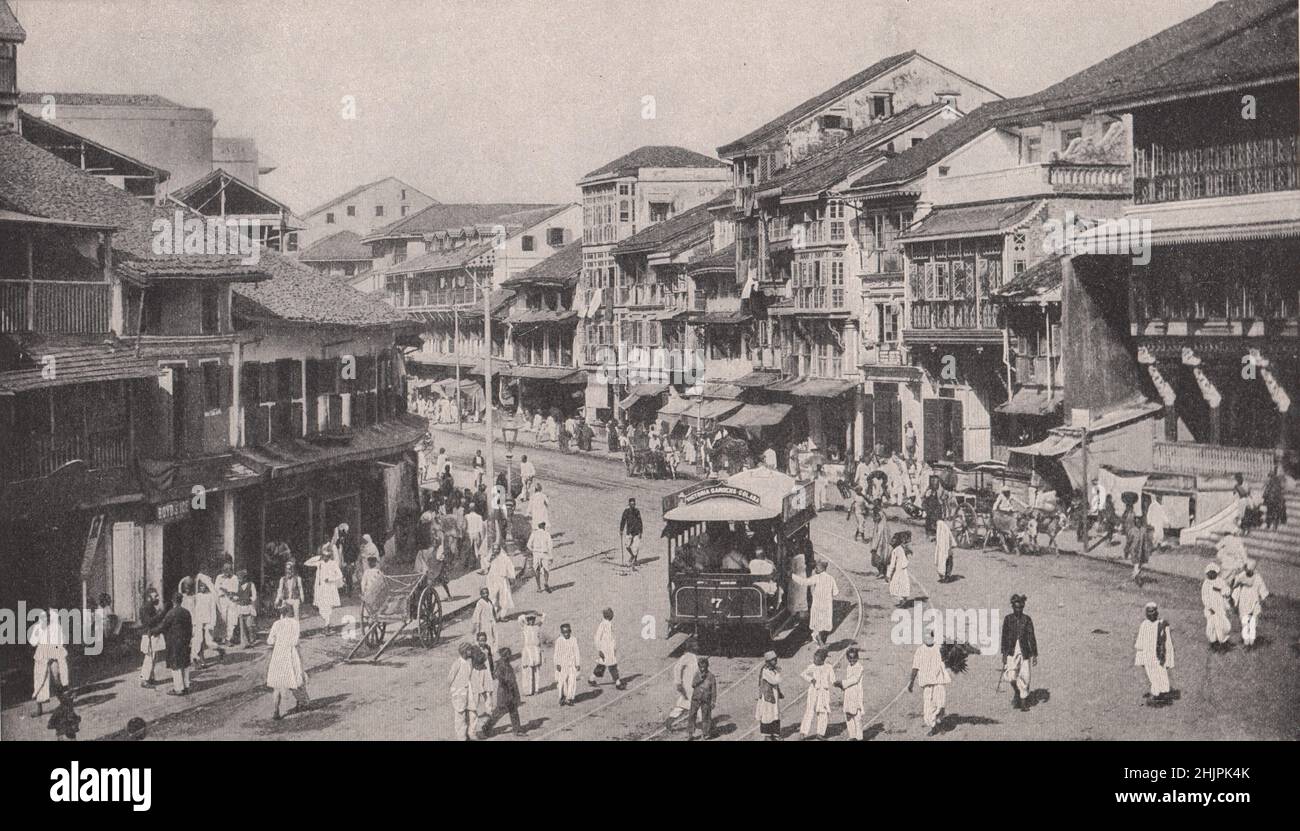 One of the Busy Native streets of Bombay, traversed by a Modern Tram ...