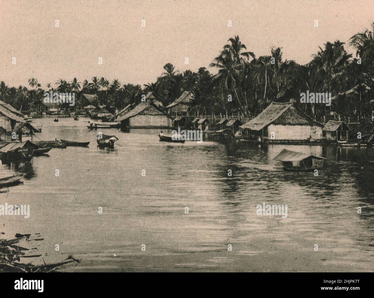 Backed by tall palms, & with the river for its high street, Sambas, in ...