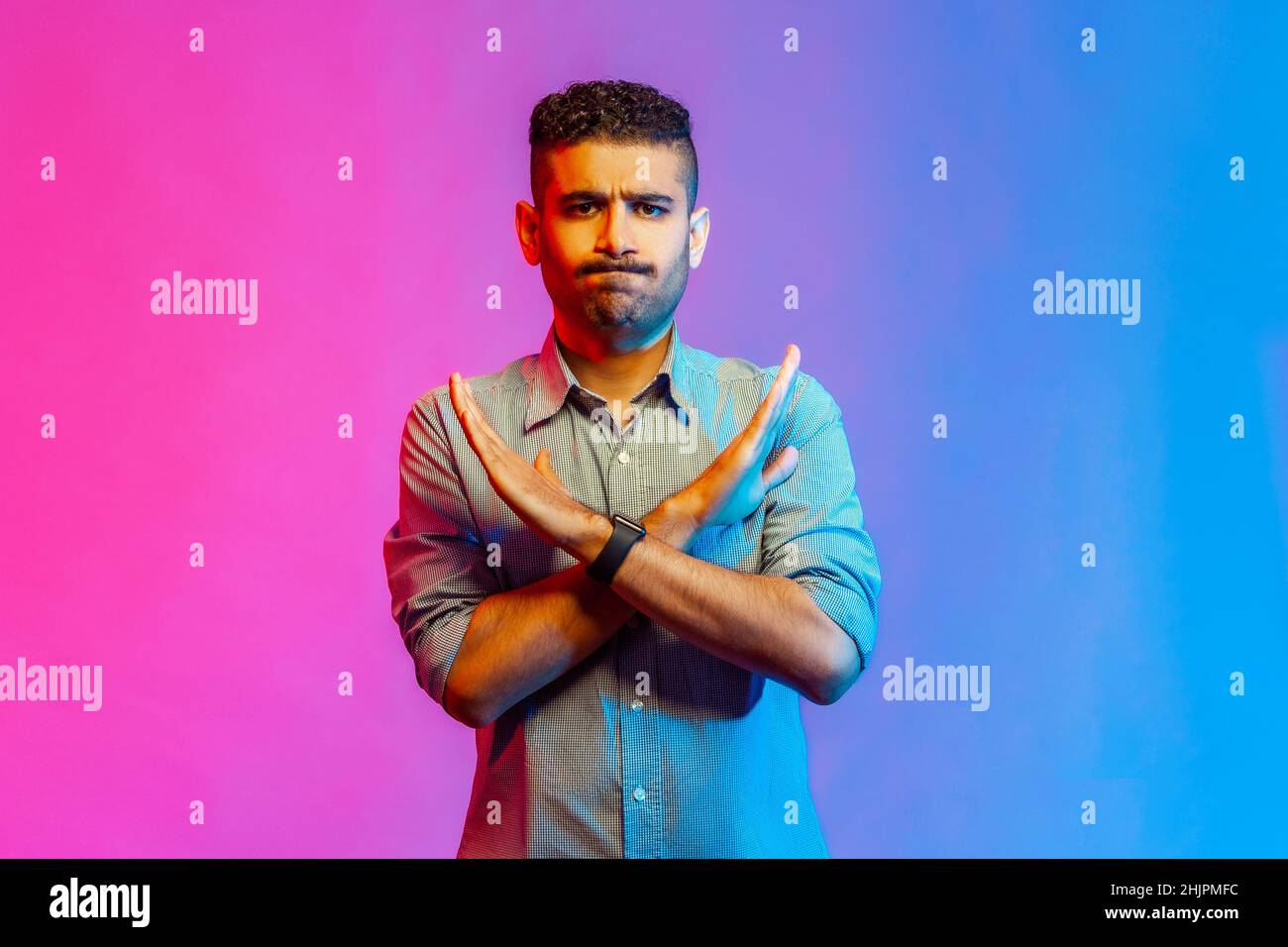 No way, absolutely not. Portrait of man in shirt showing x sign with ...