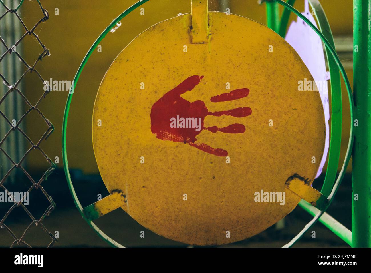 Red hand-print on an abandoned metal surface in an amusement park in ...