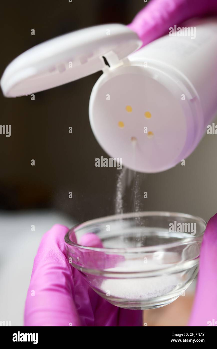 Woman's Hand Using Talcum Powder On Grey Background Stock Photo - Alamy