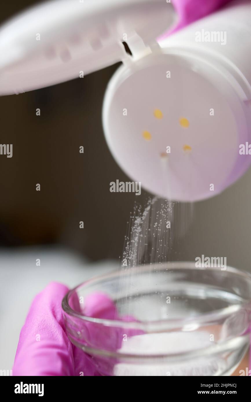 Woman's Hand Using Talcum Powder On Grey Background Stock Photo - Alamy