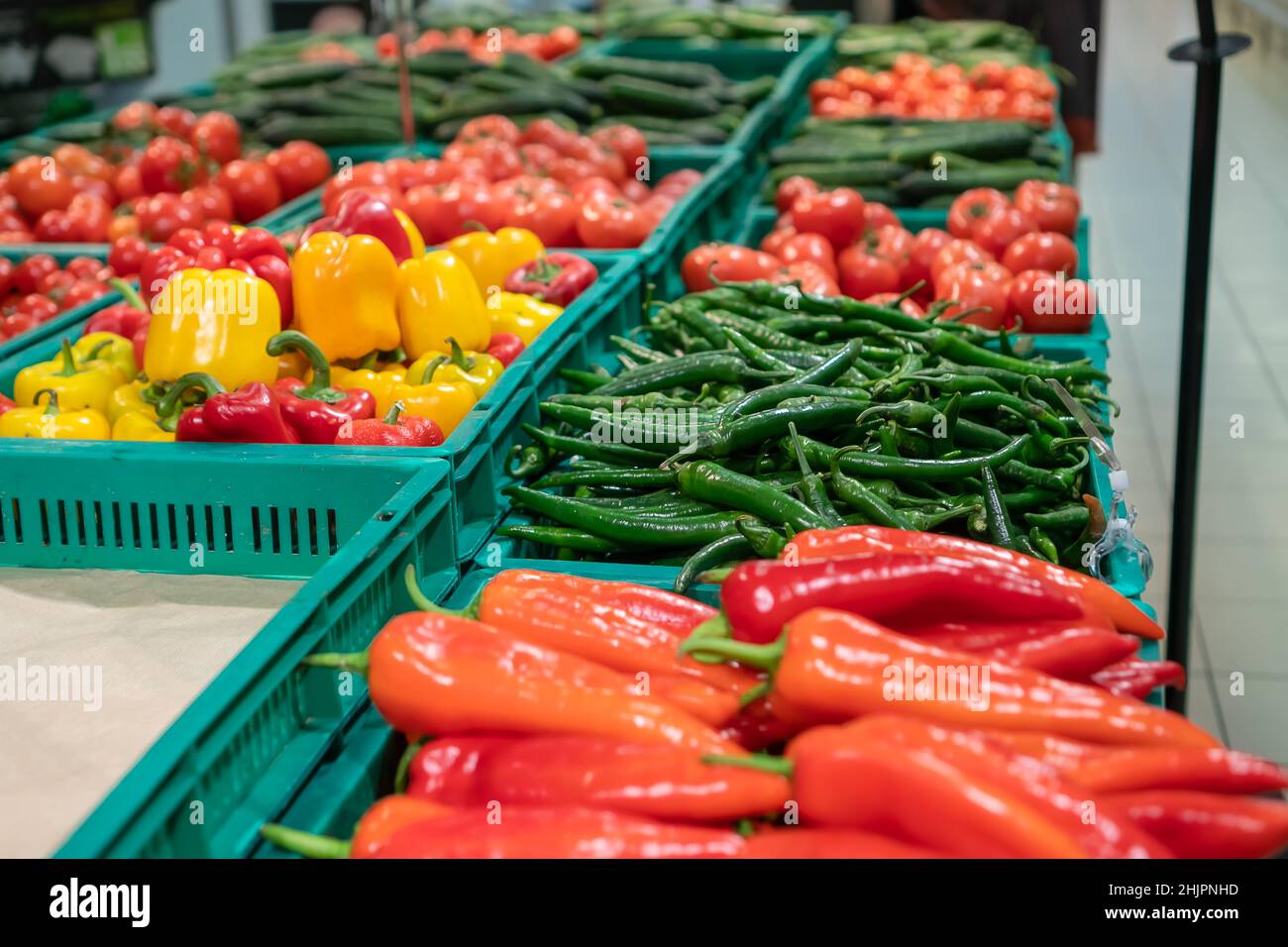 Fresh, bright, ripe vegetables in boxes on the counter in the store ...