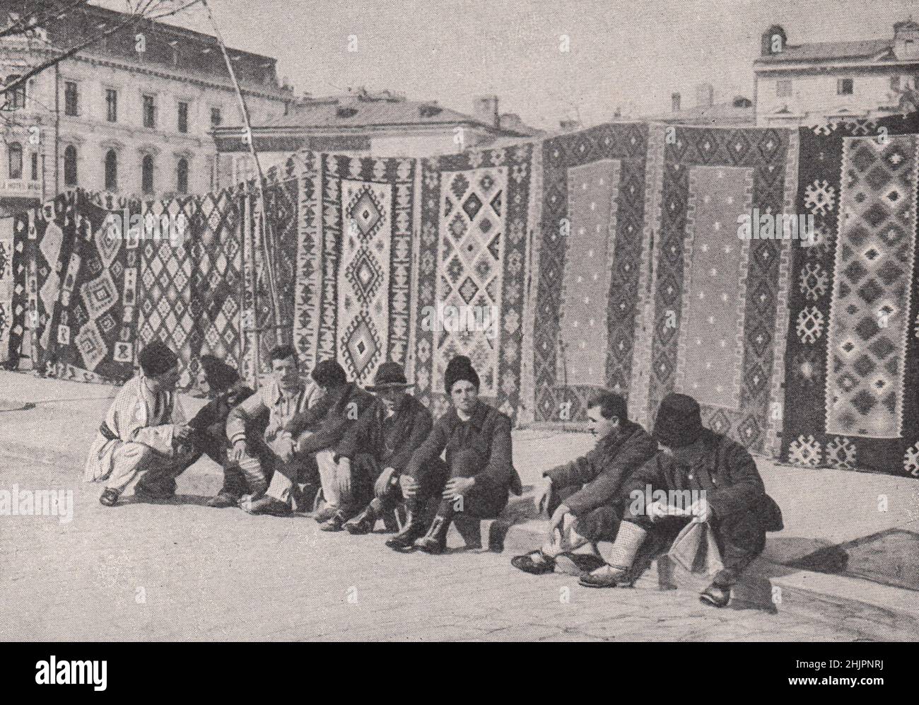 Carpet-Sellers display their wares in an open-air market. Romania ...