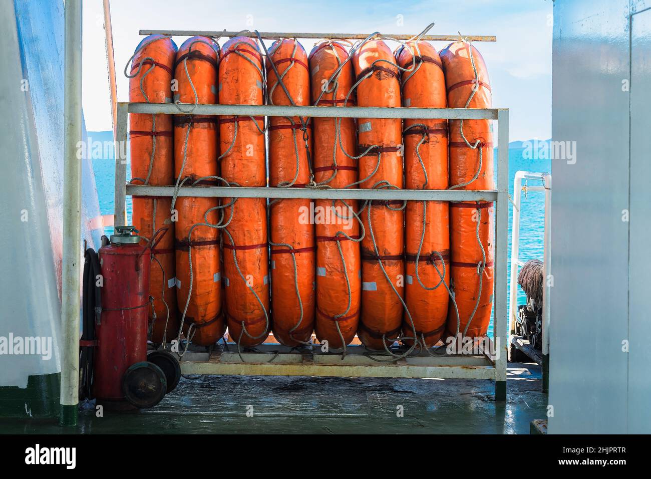 Orange inflatable lifeboats on ferry deck for emergencies and maritime ...