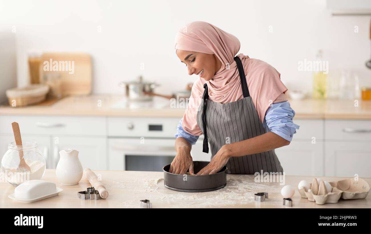 Happy Housewife. Young Islamic Lady In Hijab And Apron Baking At Home ...