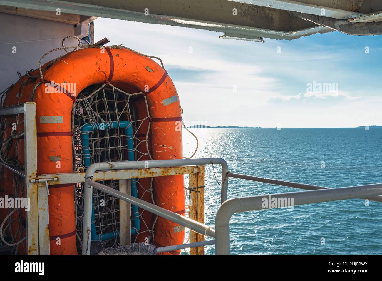 Orange inflatable lifeboats on ferry deck for emergencies and maritime ...