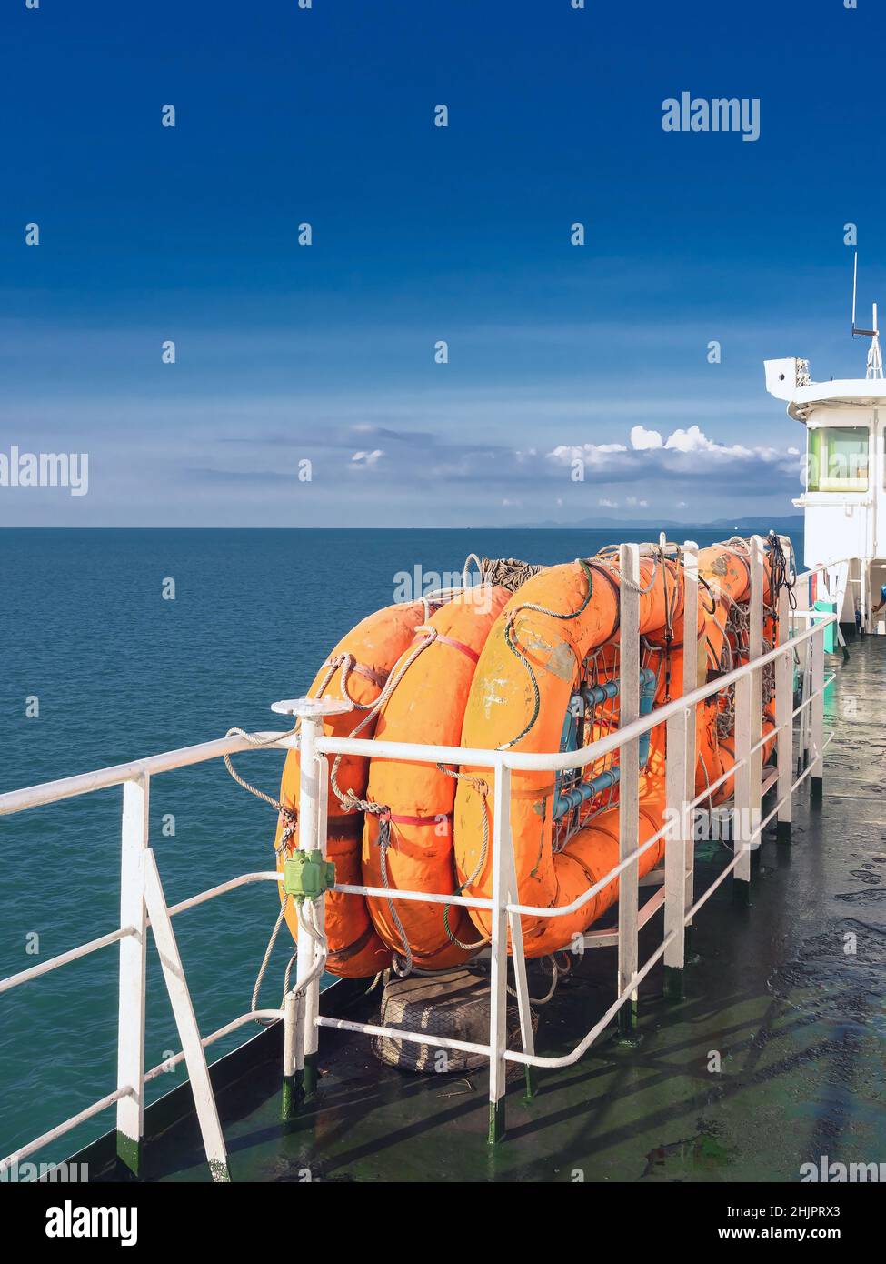 Orange inflatable lifeboats on ferry deck for emergencies and maritime ...