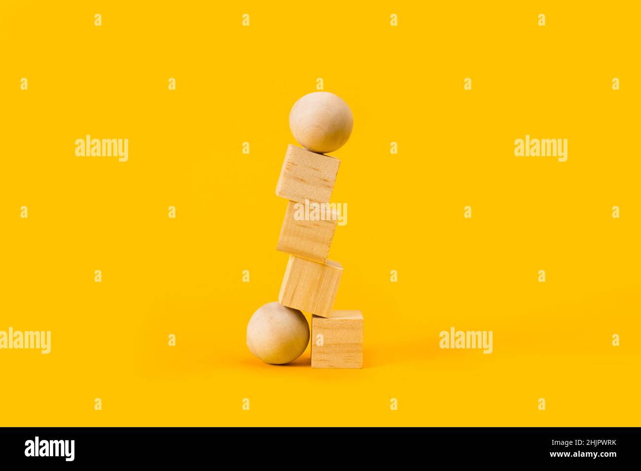 Wooden blocks and balls in a heap on a yellow background Stock Photo ...