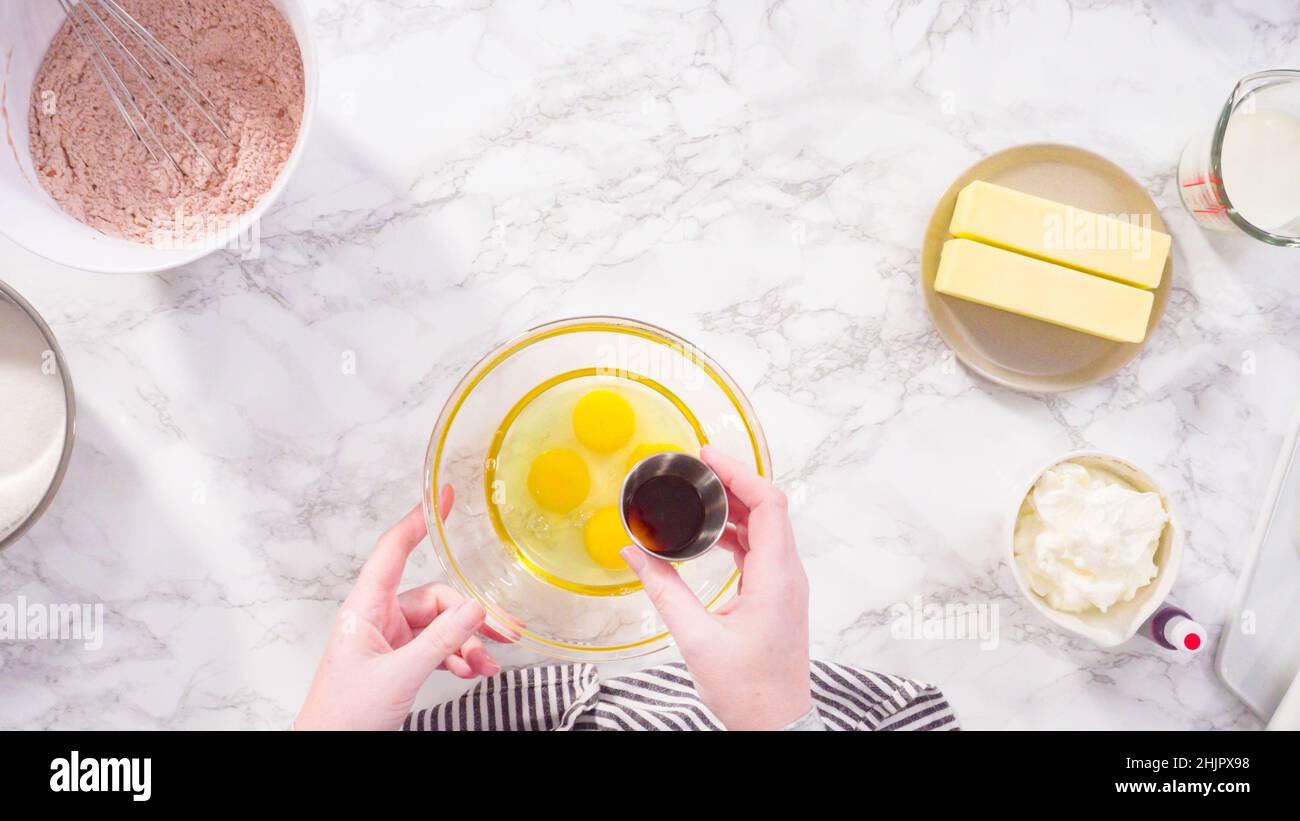 Flat lay. Step by step. Mixing wet ingredients in a glass mixing bowl ...