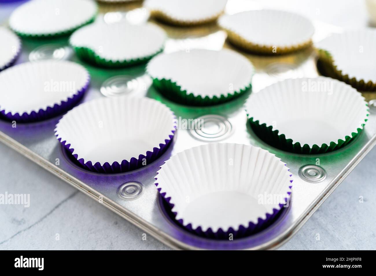 Colorful foil baking cupcake liners in cupcake pan Stock Photo - Alamy