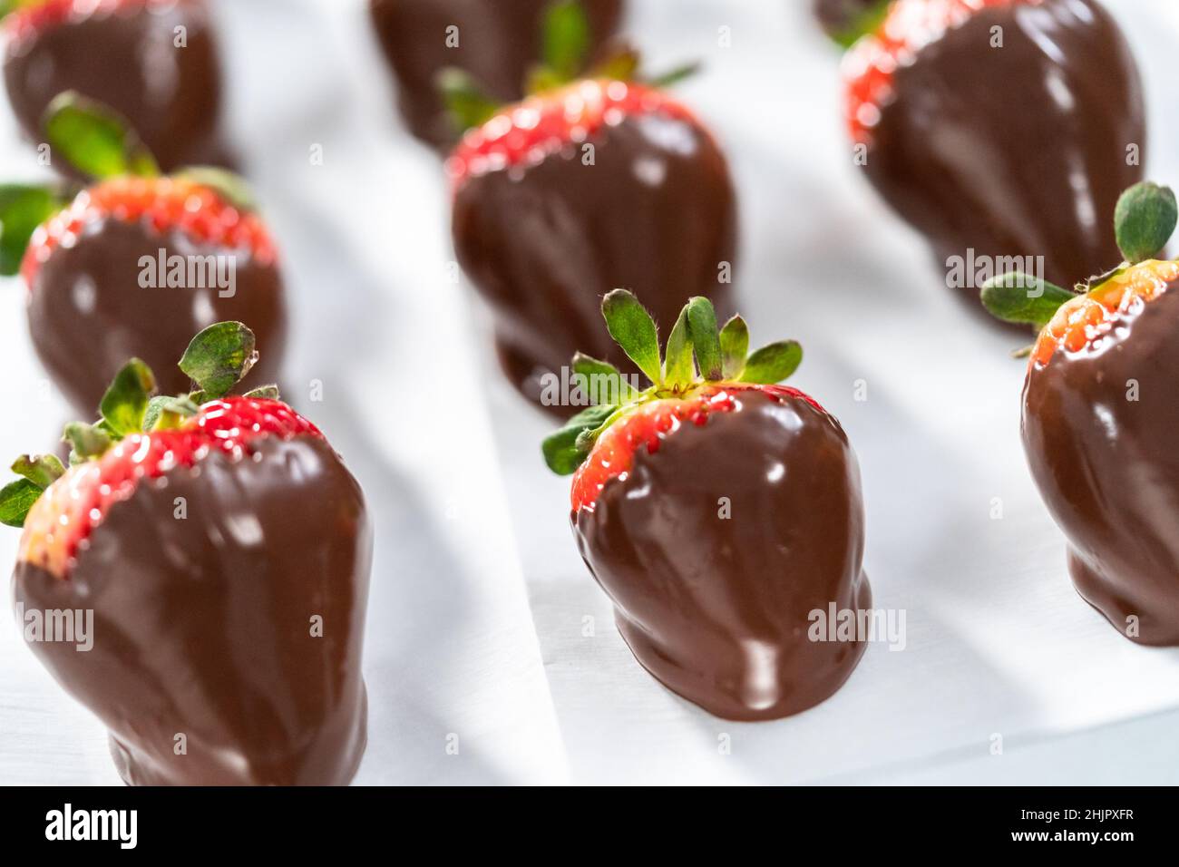 Making white and dark chocolate dipped strawberries Stock Photo - Alamy