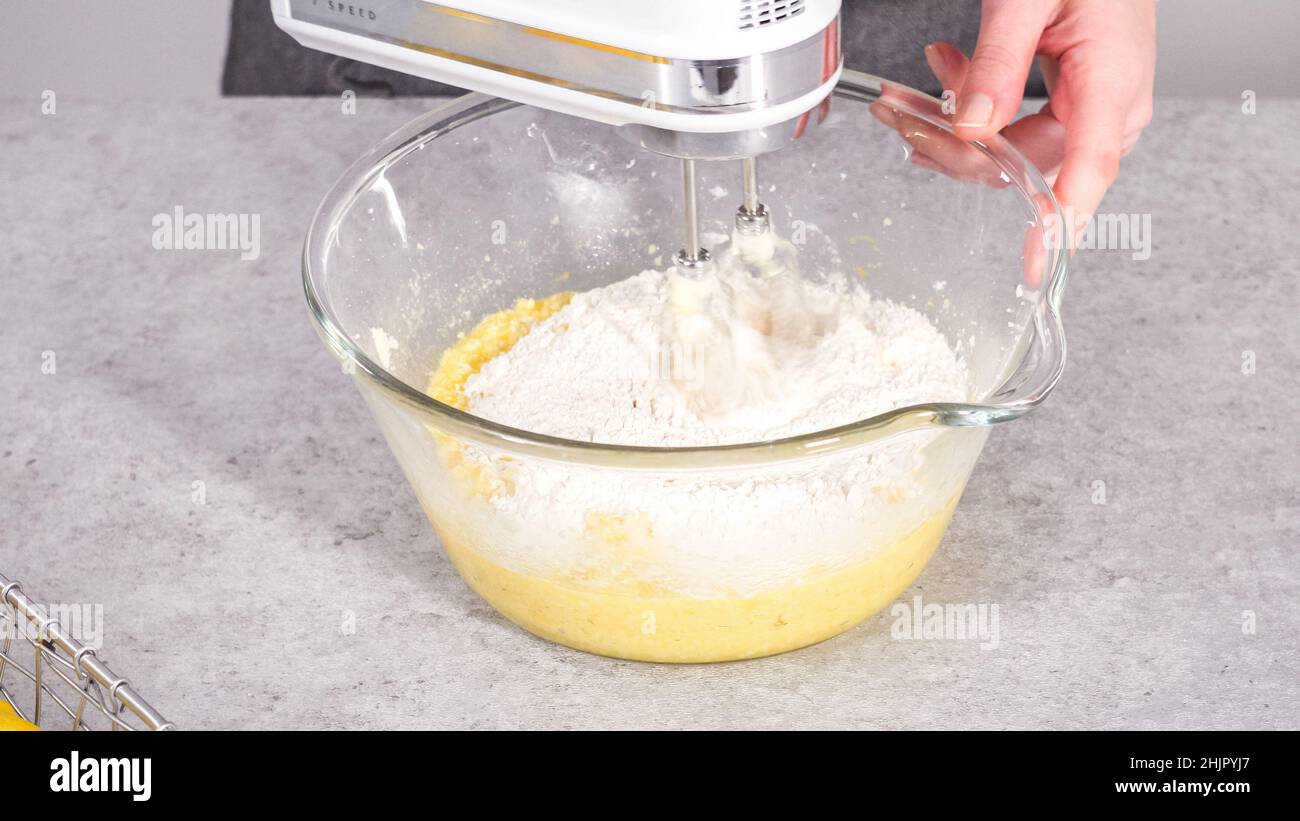 Step by step. Mixing ingredients in a glass mixing bowl to prepare ...