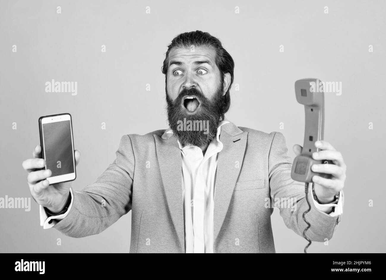 Modern mobile phone and old vintage classic telephone. Technology is ...