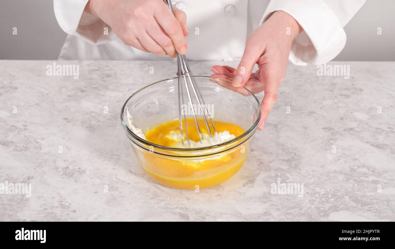 Step by step. Mixing ingredients in a glass mixing bowl to bake ...