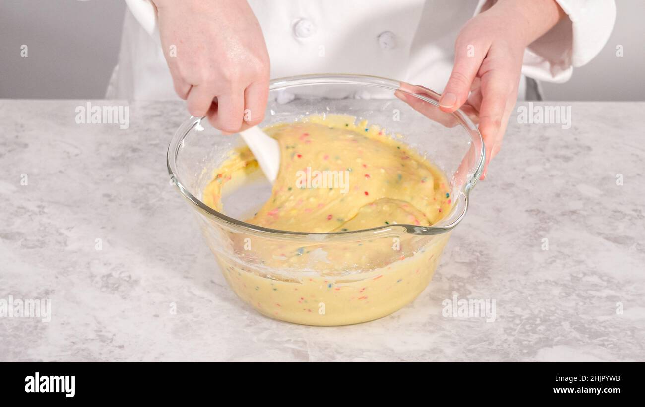 Step by step. Folding into the cake batter rainbow sprinkles to bake ...