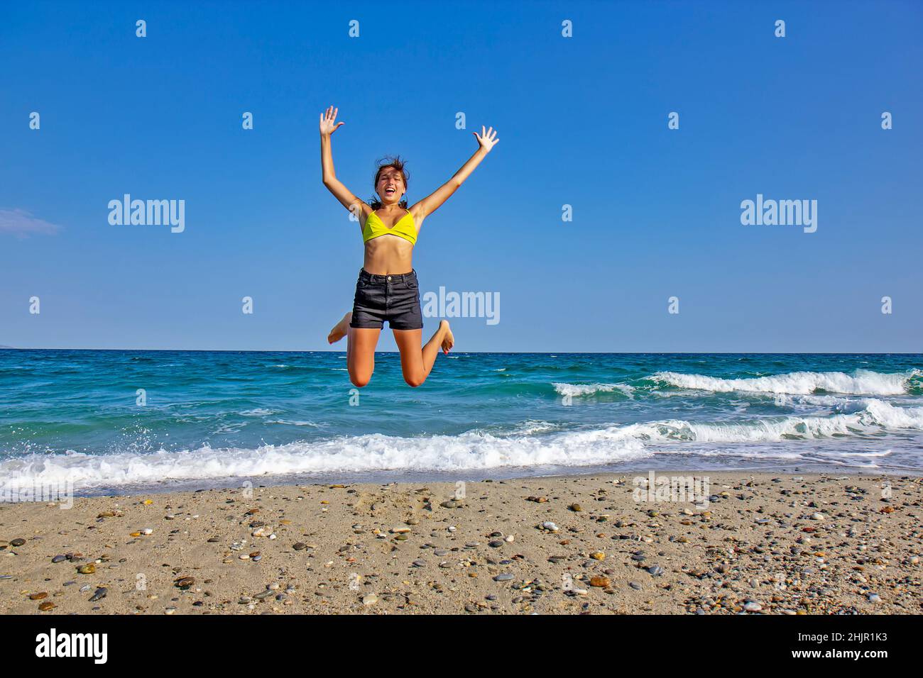 Woman beach jumping swimsuit hi-res stock photography and images - Alamy