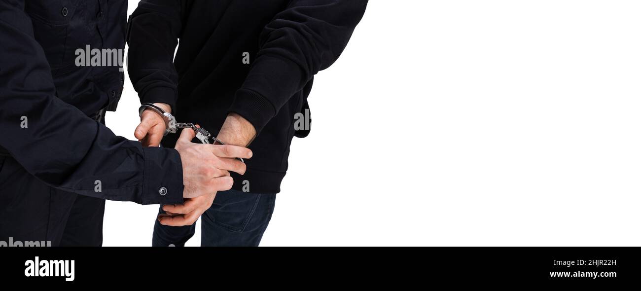 Close-up male hands in handcuffs. Policeman officer arrests a criminal ...
