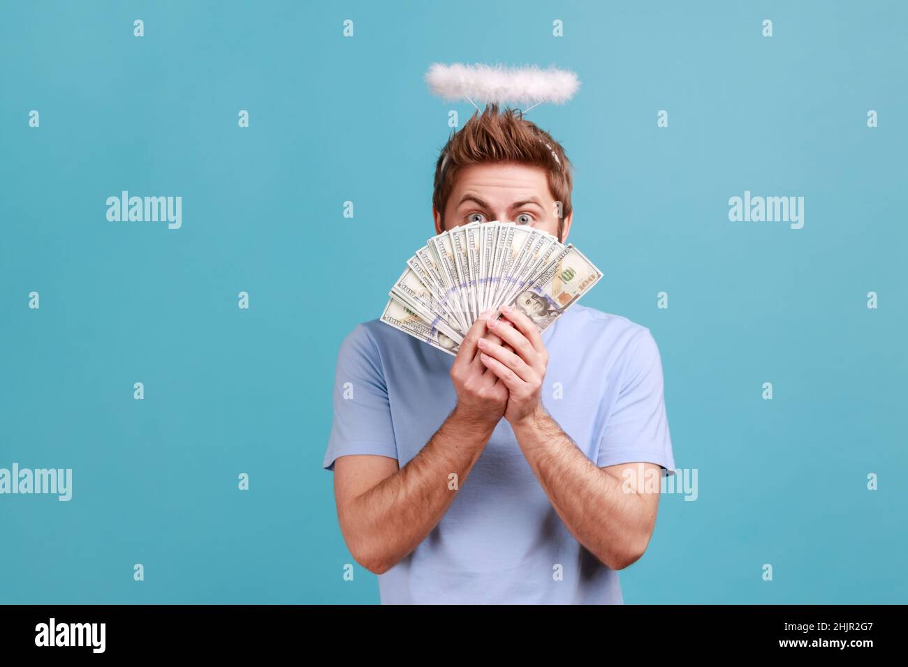Portrait of young adult bearded angelic man with holy nimbus over head ...