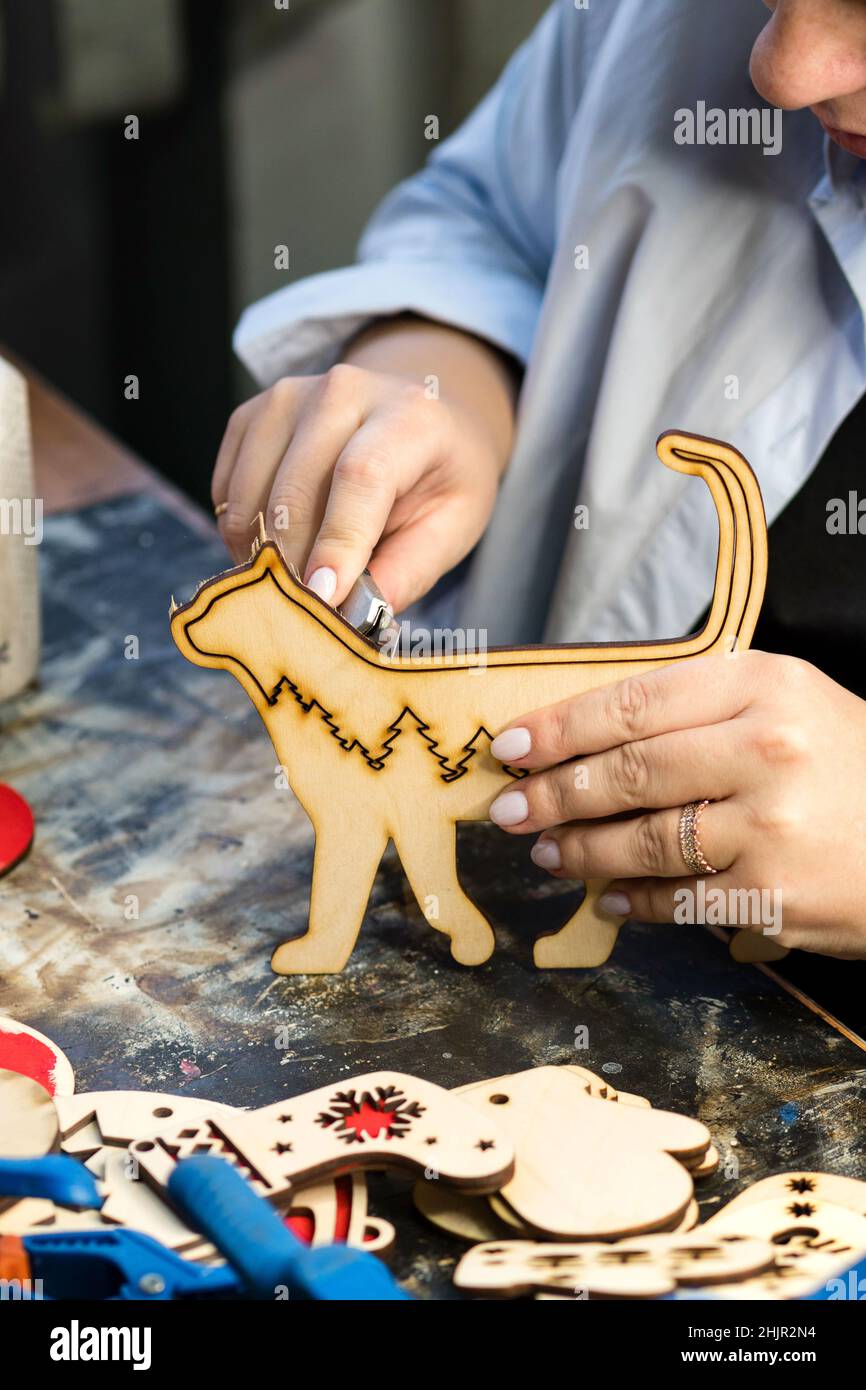 Closeup process making handmade wooden Christmas toys in carpentry ...