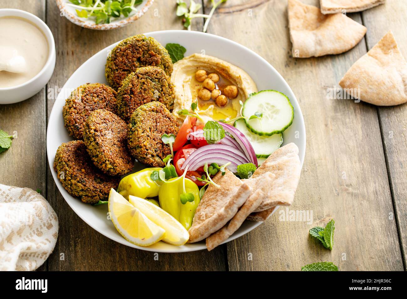 Baked falafel bowl with hummus and vegetables Stock Photo - Alamy
