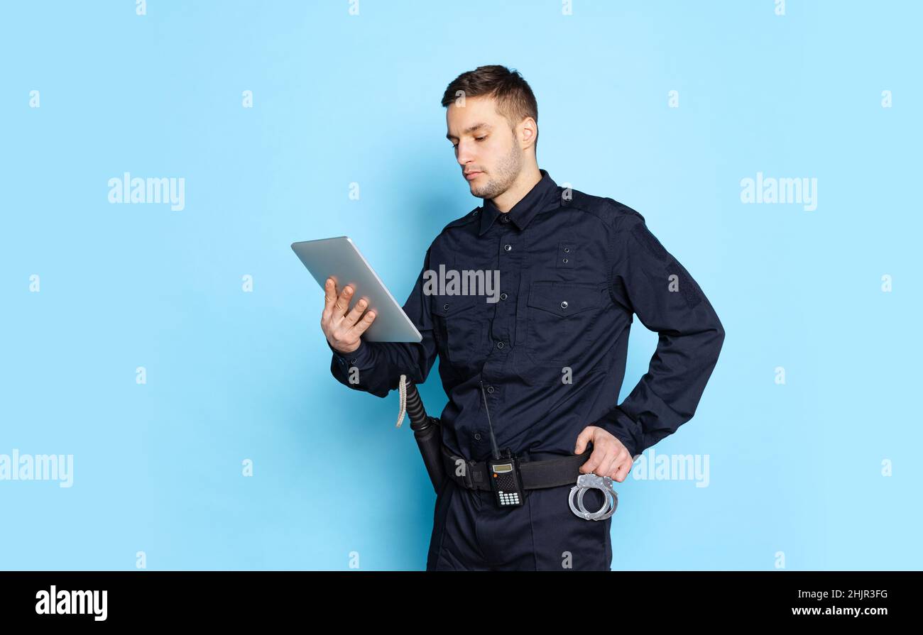 Police office using tablet hi-res stock photography and images - Alamy