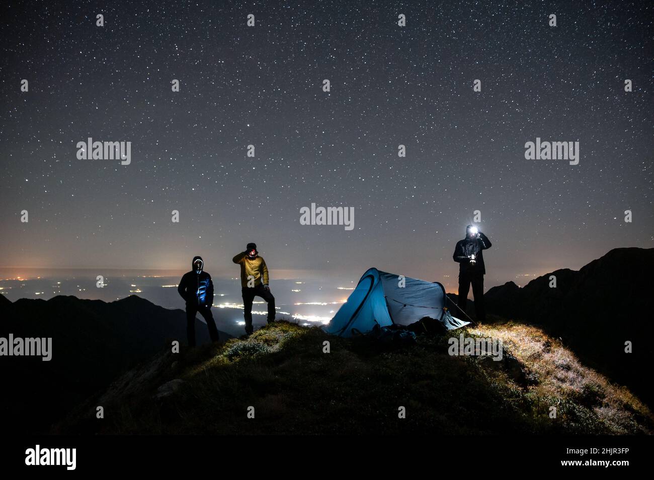 Man standing with headlamp under the sky full of stars Stock Photo - Alamy