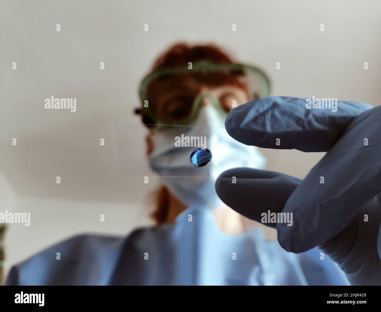 Medical staff observing a sample Stock Photo - Alamy