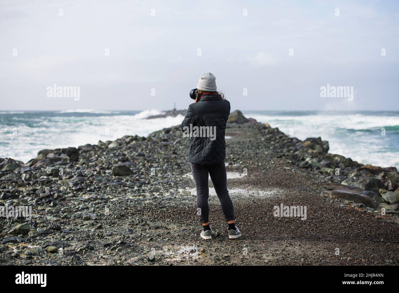 Female photographer taking photograph ocean hi-res stock photography ...