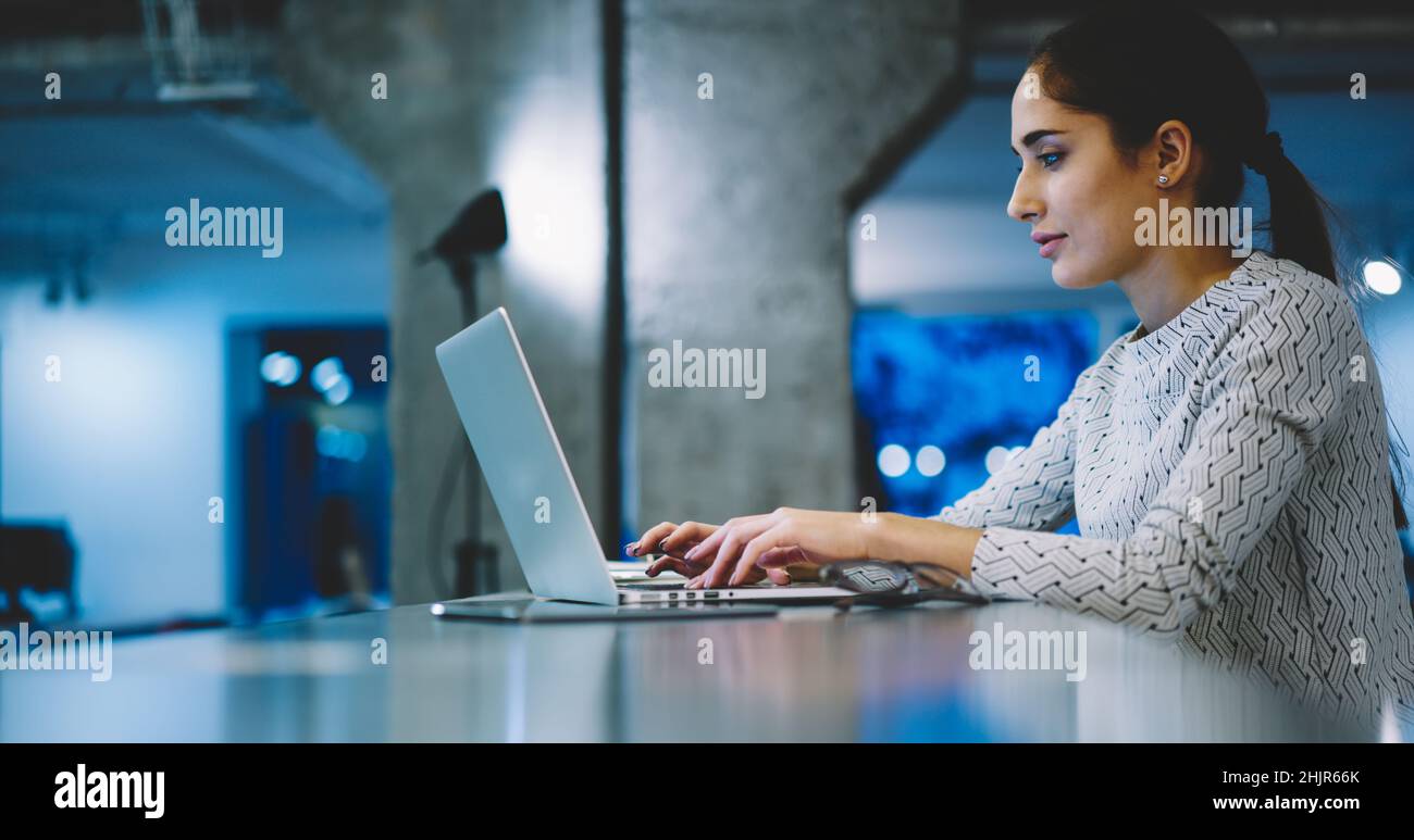Focused woman working on laptop Stock Photo - Alamy