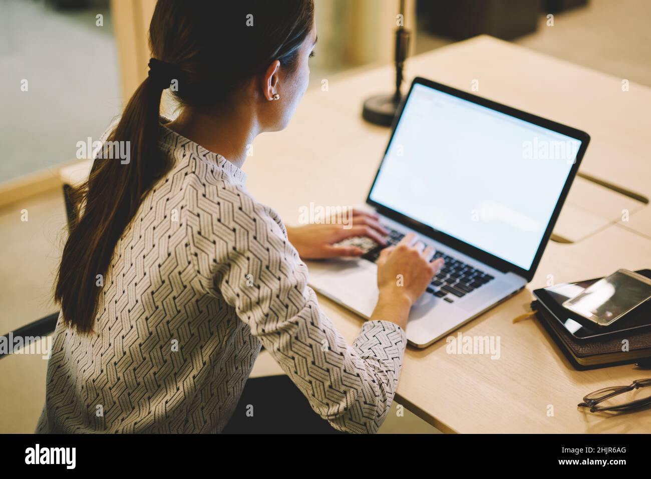 Unrecognizable female looking at screen and typing Stock Photo - Alamy