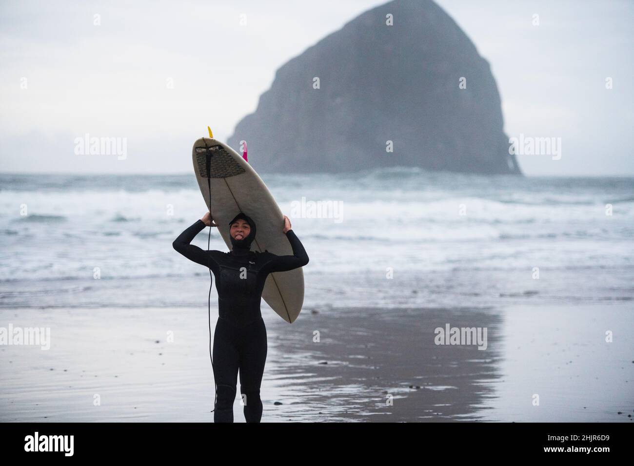 Female surfer having fun after catching waves is Coastal Oregon Stock ...