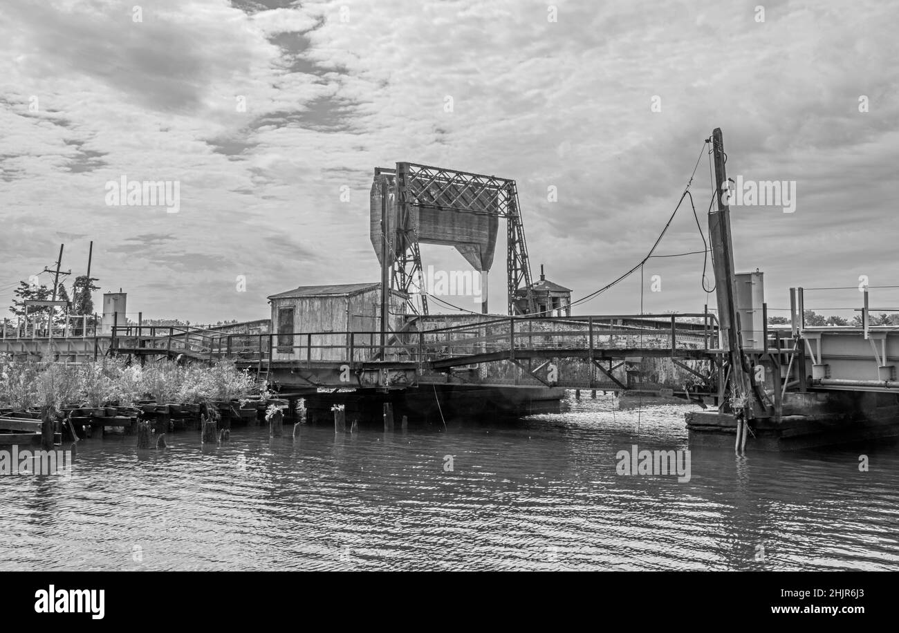 An old bascule railroad bridge (also referred to as a drawbridge or a ...