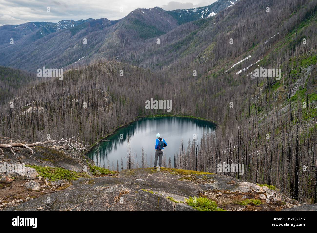 Female stands above an alpine lake in the Entiat river valley Stock ...