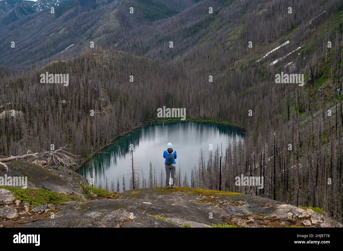 Female stands above an alpine lake in the Entiat river valley Stock ...