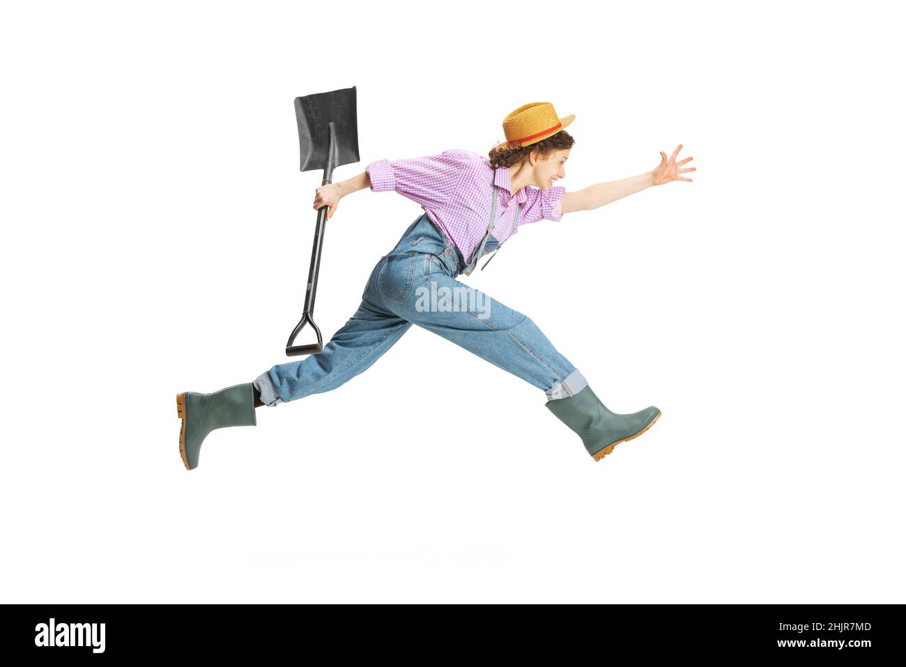 Dynamic portrait of young girl, female gardener in work uniform and ...