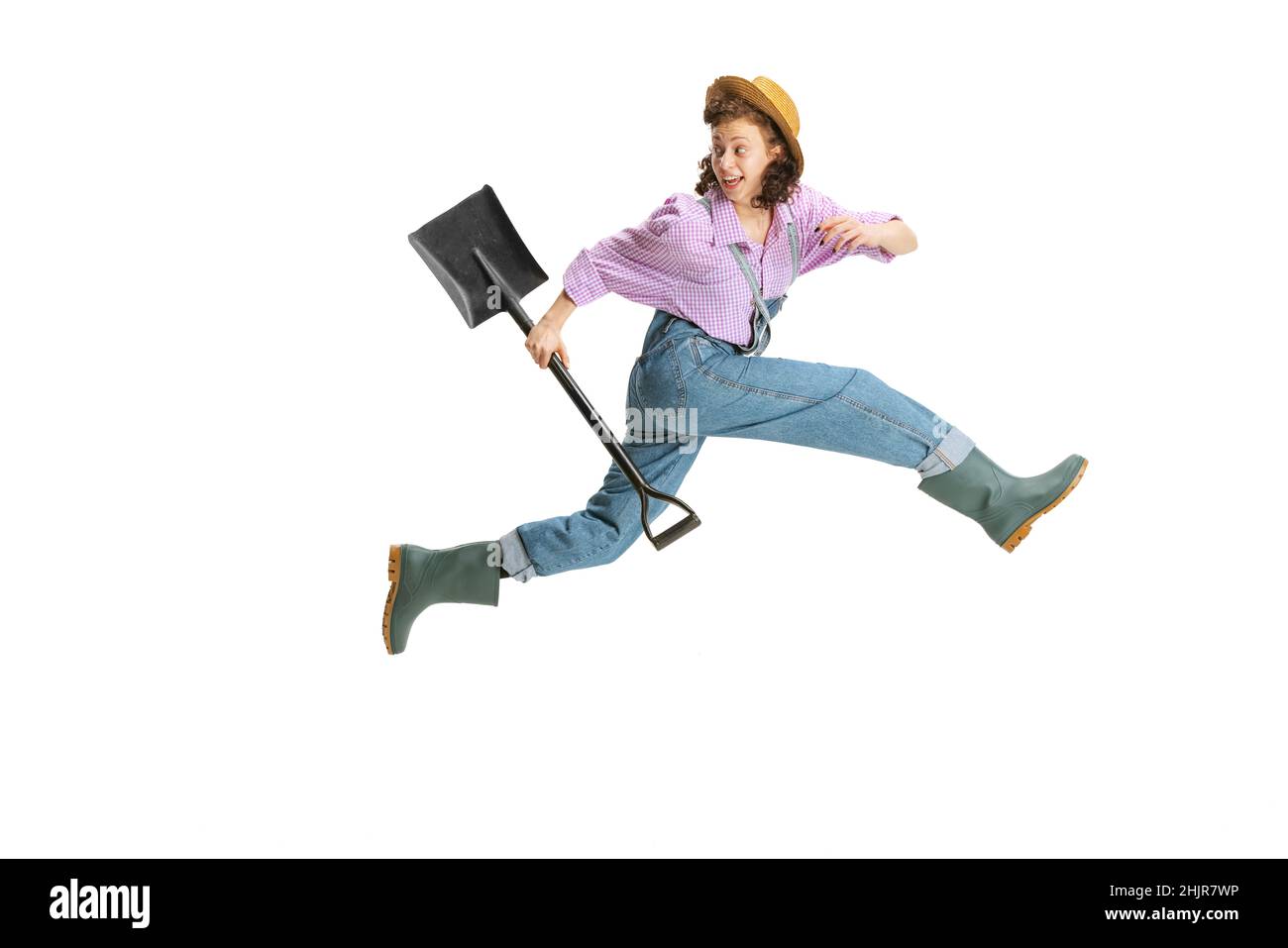 Dynamic portrait of young girl, female gardener in work uniform and ...