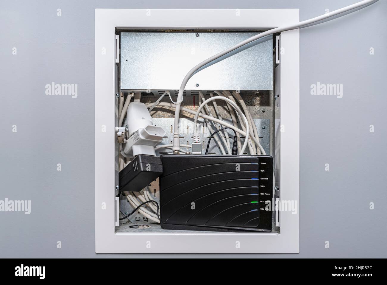 An open multimedia box with an internet modem and antenna cables ...