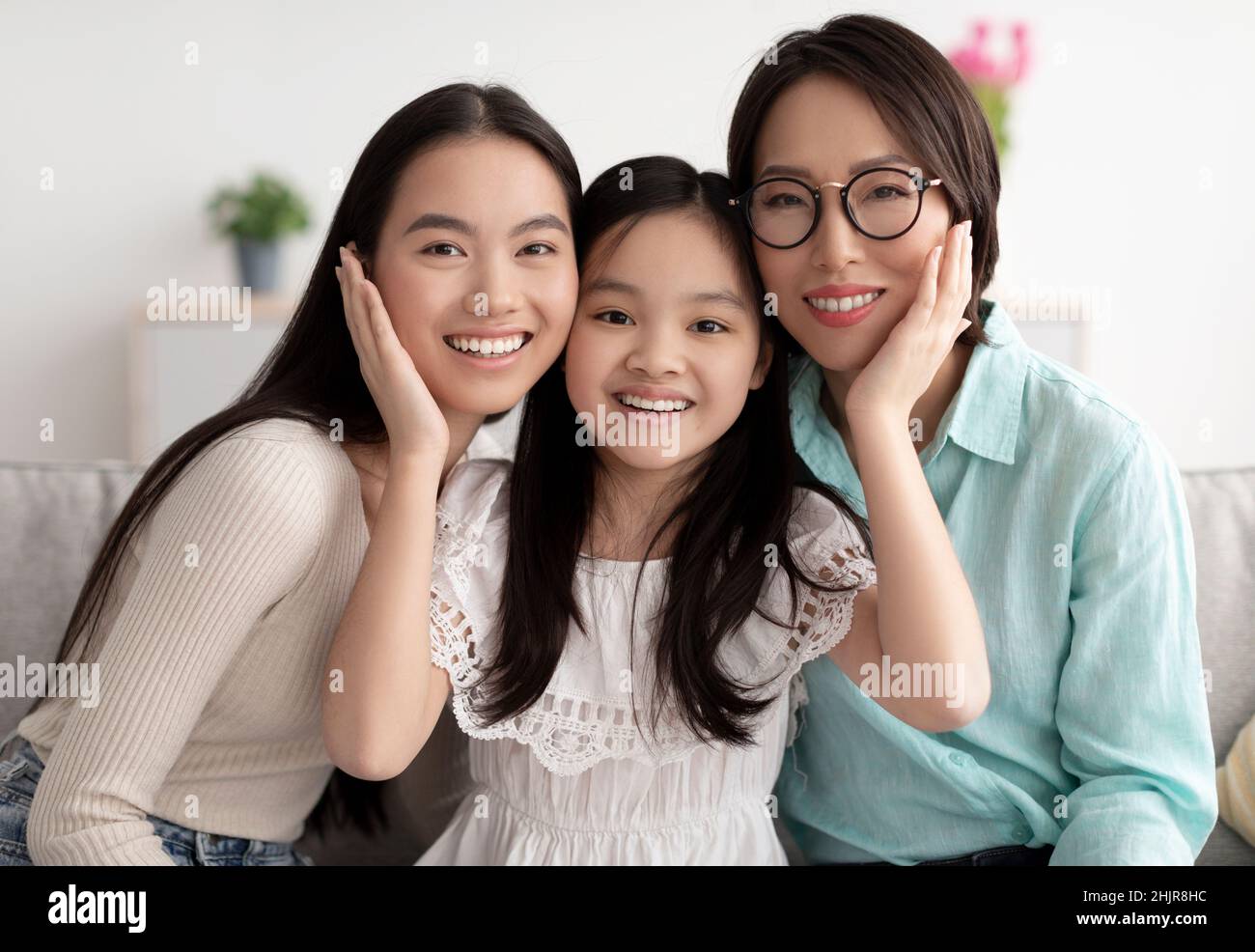 Portrait of cheerful multi generation Asian family posing and smiling ...