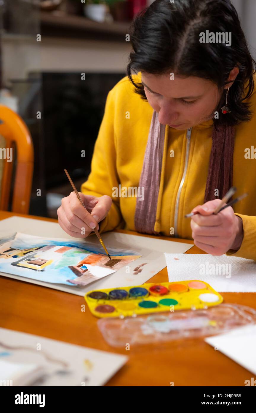 Process of creative art workshop. Artist painting colorful architecture ...