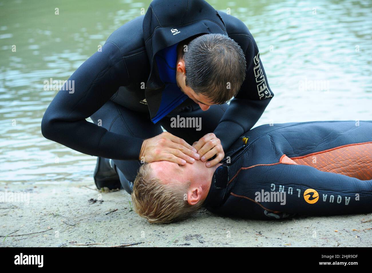 Artificial respiration. Lifeguard giving drowning mouth-to-mouth ...