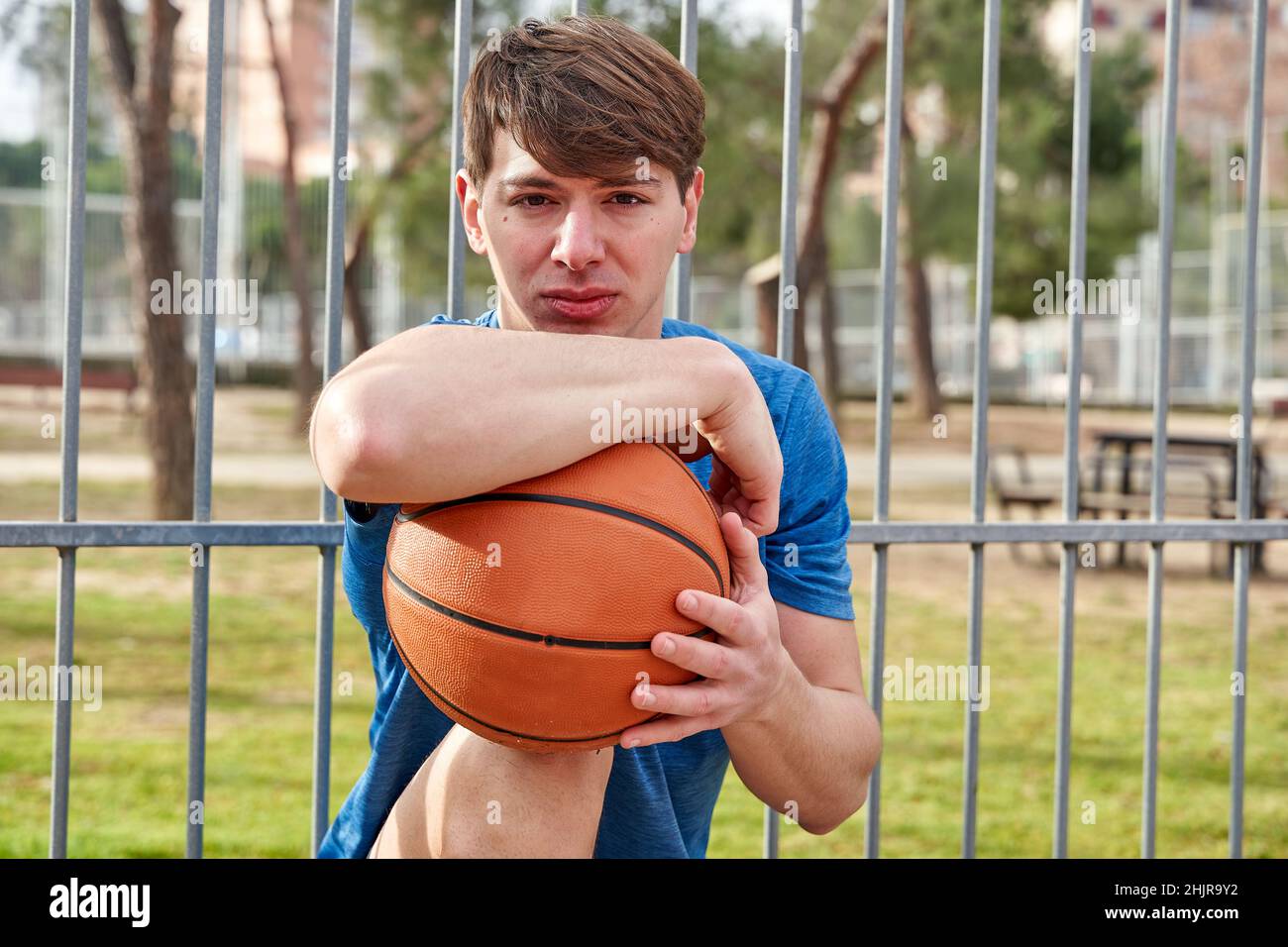 portrait of a man looking at the camera with a basketball in his hand ...