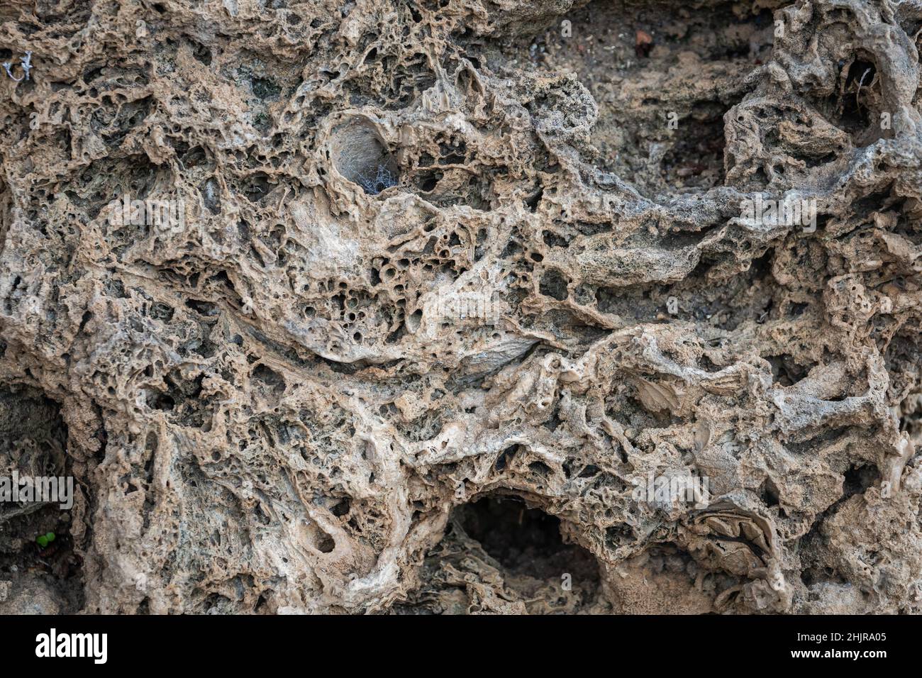 The antique wall is paved with gray stones, side view. stone texture ...
